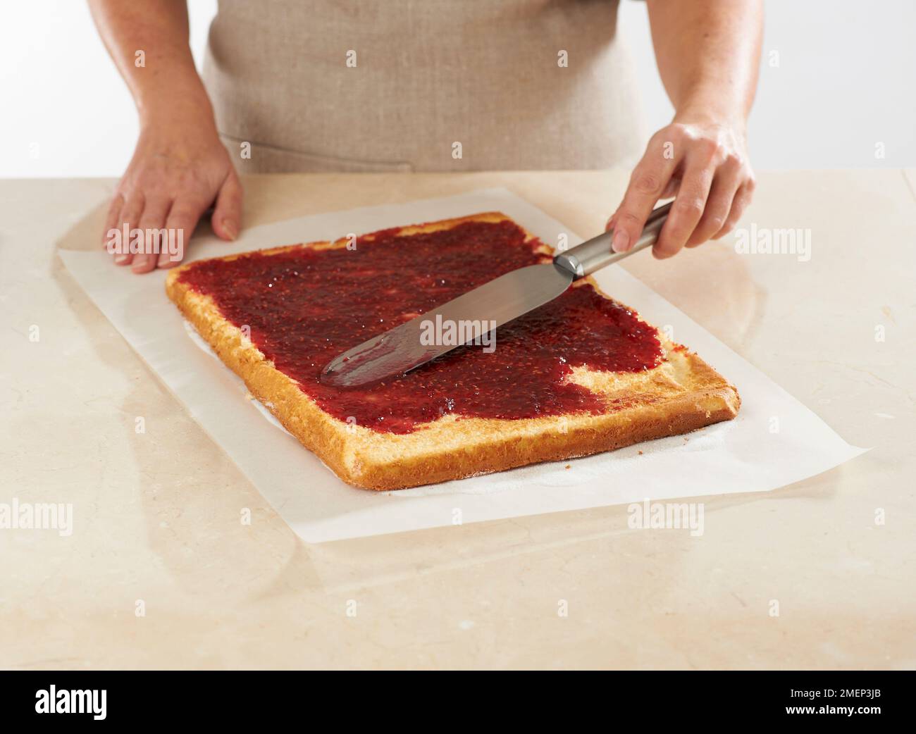 Spreading Jam onto the Swiss Roll Stock Photo - Alamy
