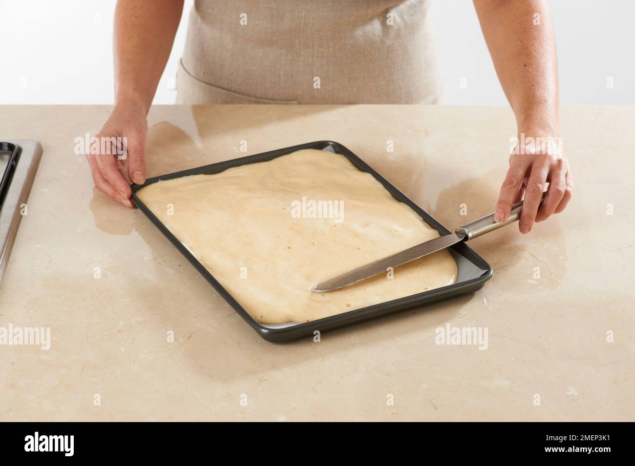 Swiss Roll, spreading mixture on baking tray Stock Photo - Alamy