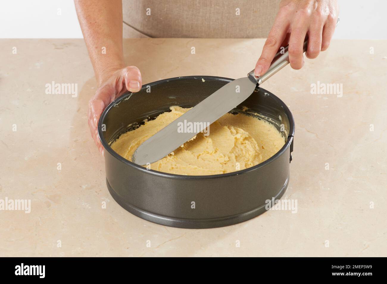Lemon Polenta Cake, smoothing mixture in tin with palette knife Stock ...