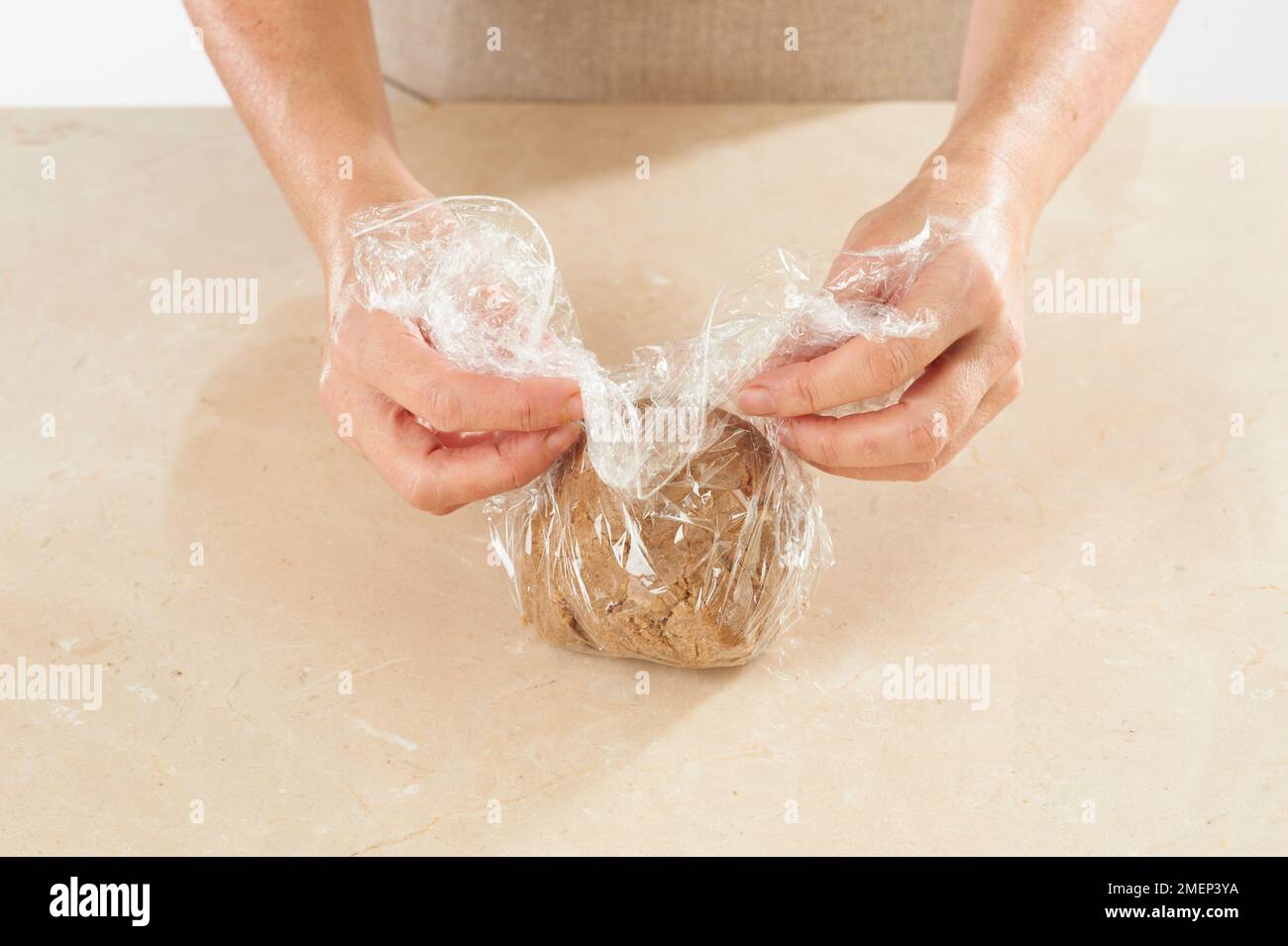 Making German Apple Cake, wrapping streusel dough ball in cling film ...