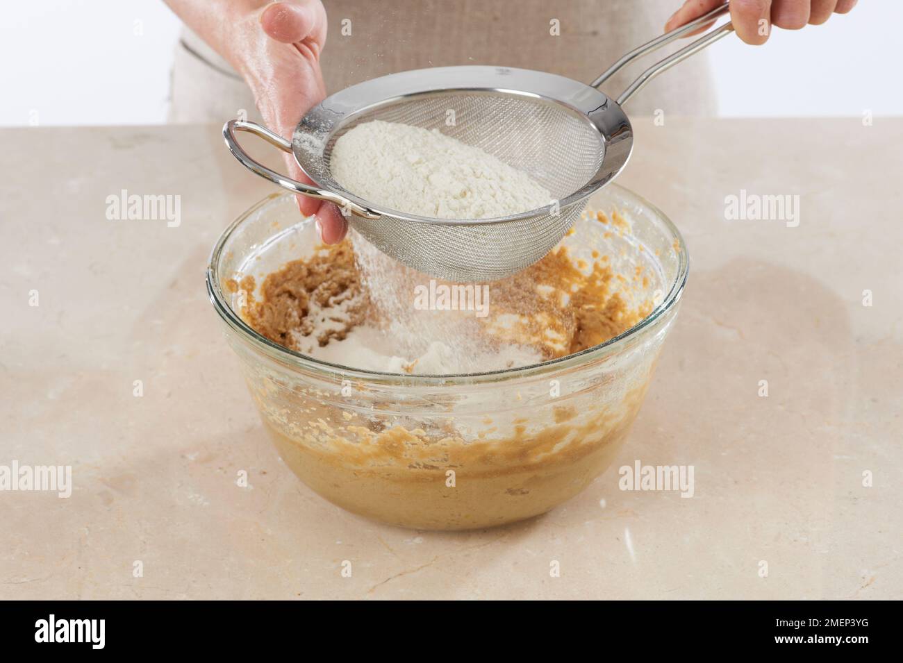 Making German Apple Cake, sifting flour onto cake mixture Stock Photo ...