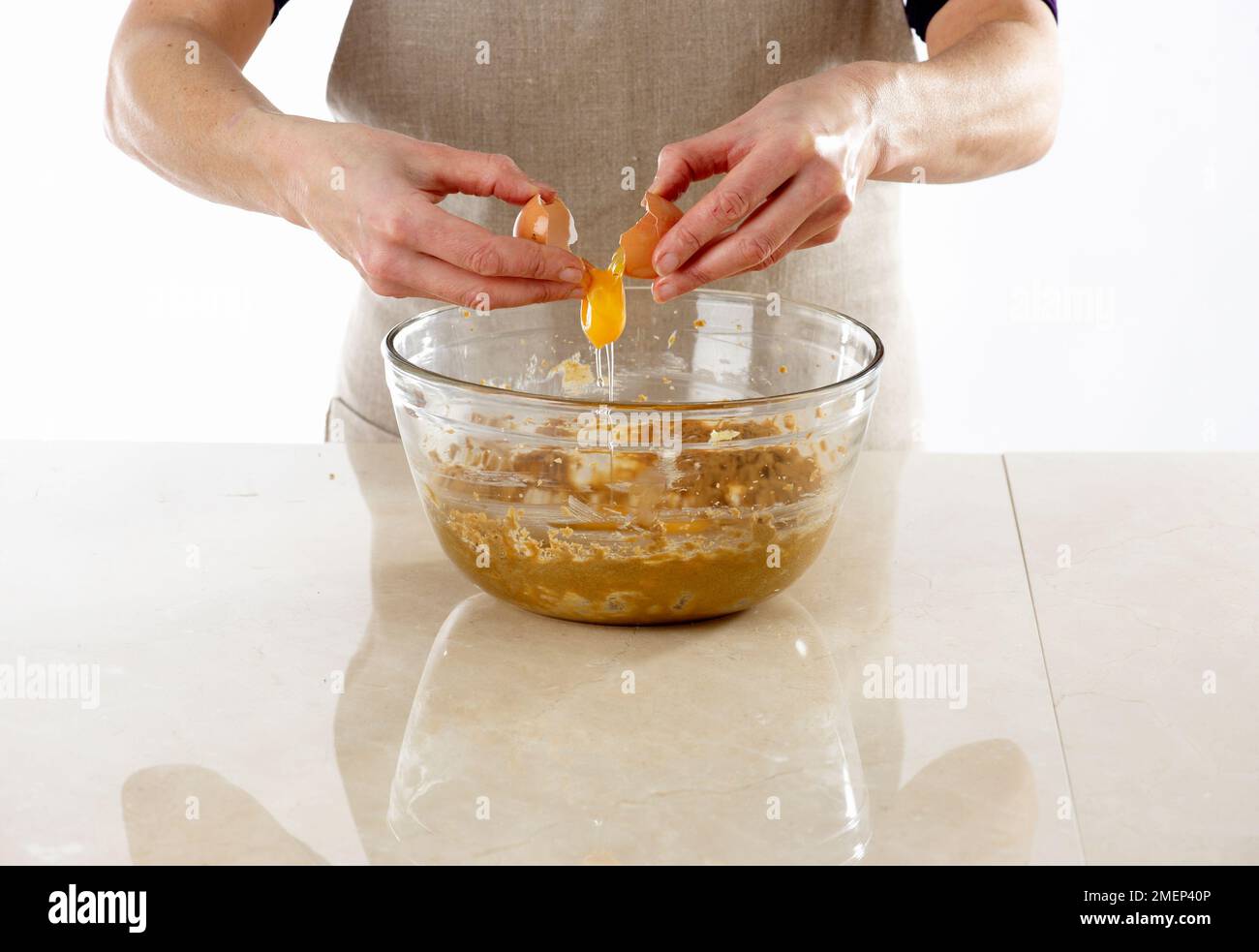 Making Rhubarb and Ginger Upside Down Cake, adding egg to cake mixture ...