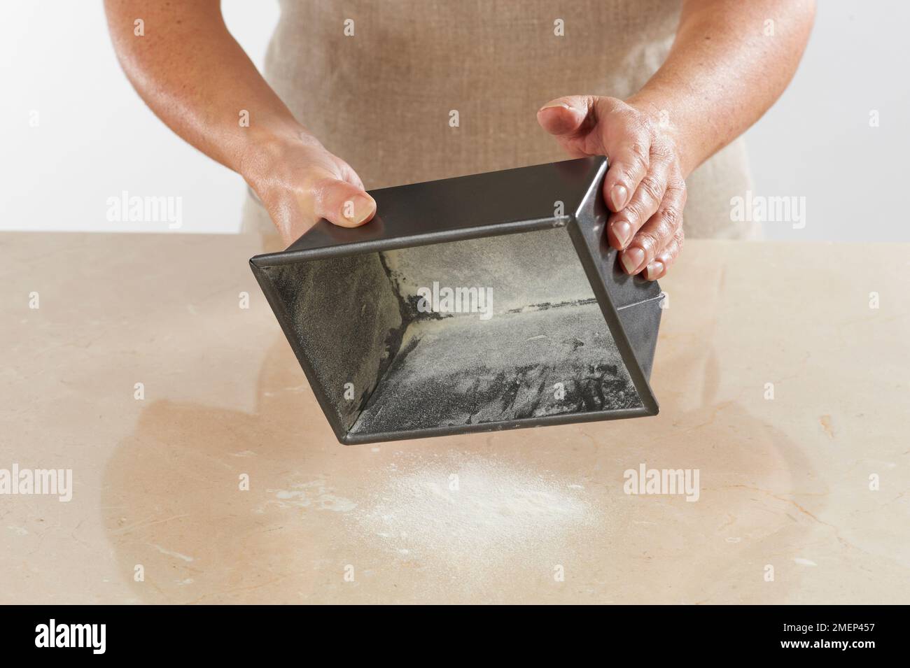 Loaf tin greased and sprinkled with flour, turning and tapping to ...