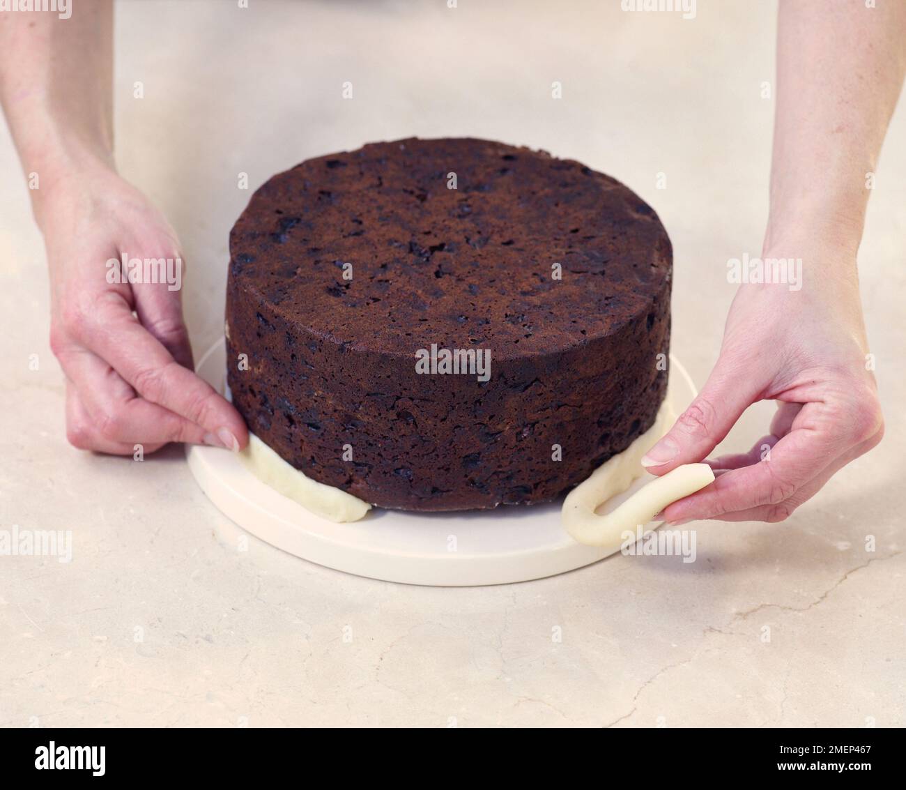 Rich Fruit Cake, wrapping marzipan around base of cake Stock Photo - Alamy