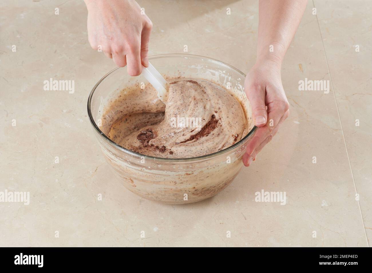 Black Forest Gateau, folding cocoa into cake mixture Stock Photo - Alamy