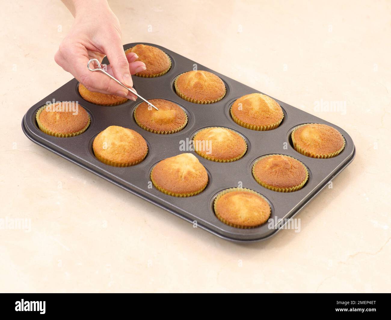 Vanilla Cream Cupcakes, testing if cakes are done by inserting a skewer ...