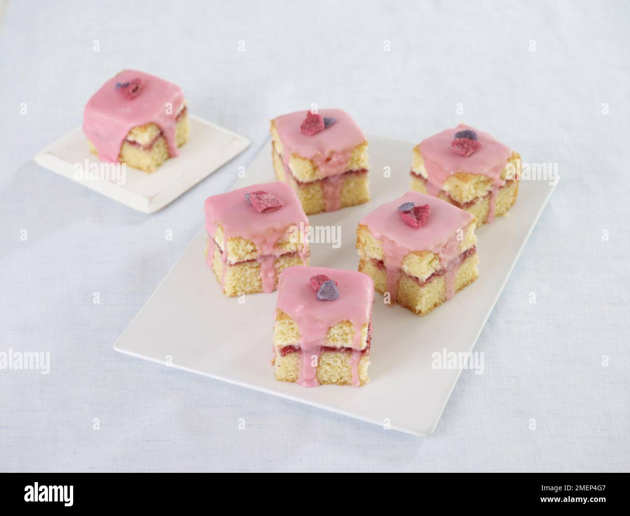 Fondant Fancies with pink icing Stock Photo - Alamy
