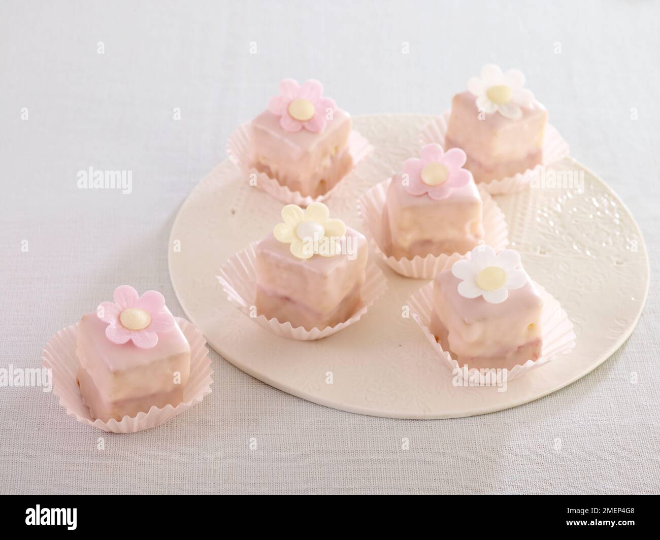Fondant Fancies with icing and edible flowers Stock Photo - Alamy