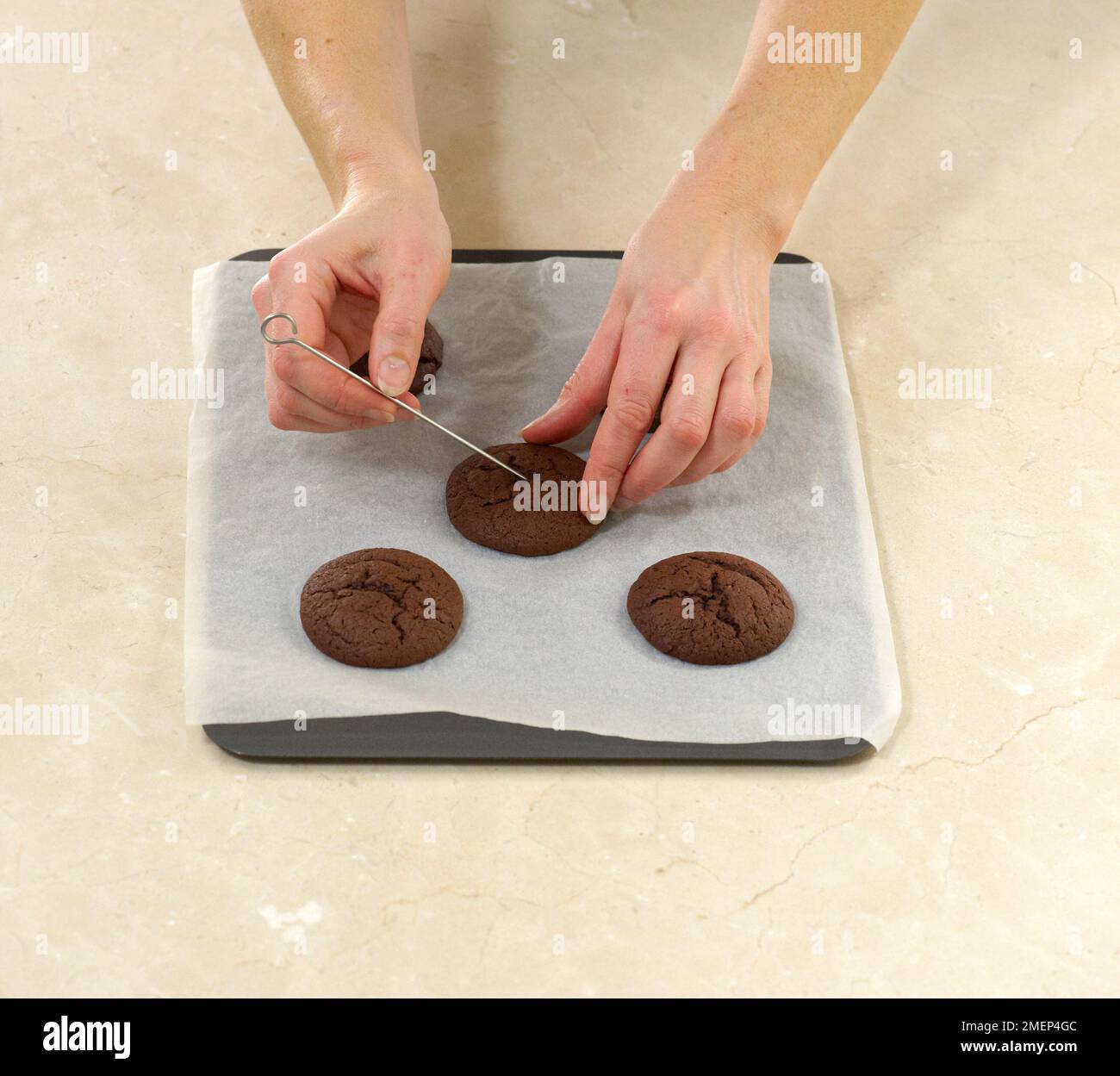 Making Whoopie Pies, inserting skewers Stock Photo - Alamy