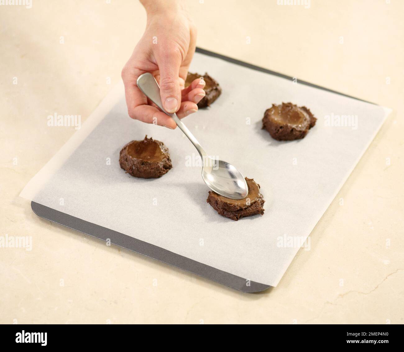 Making Whoopie Pies, smoothing surface of cakes with back of spoon ...
