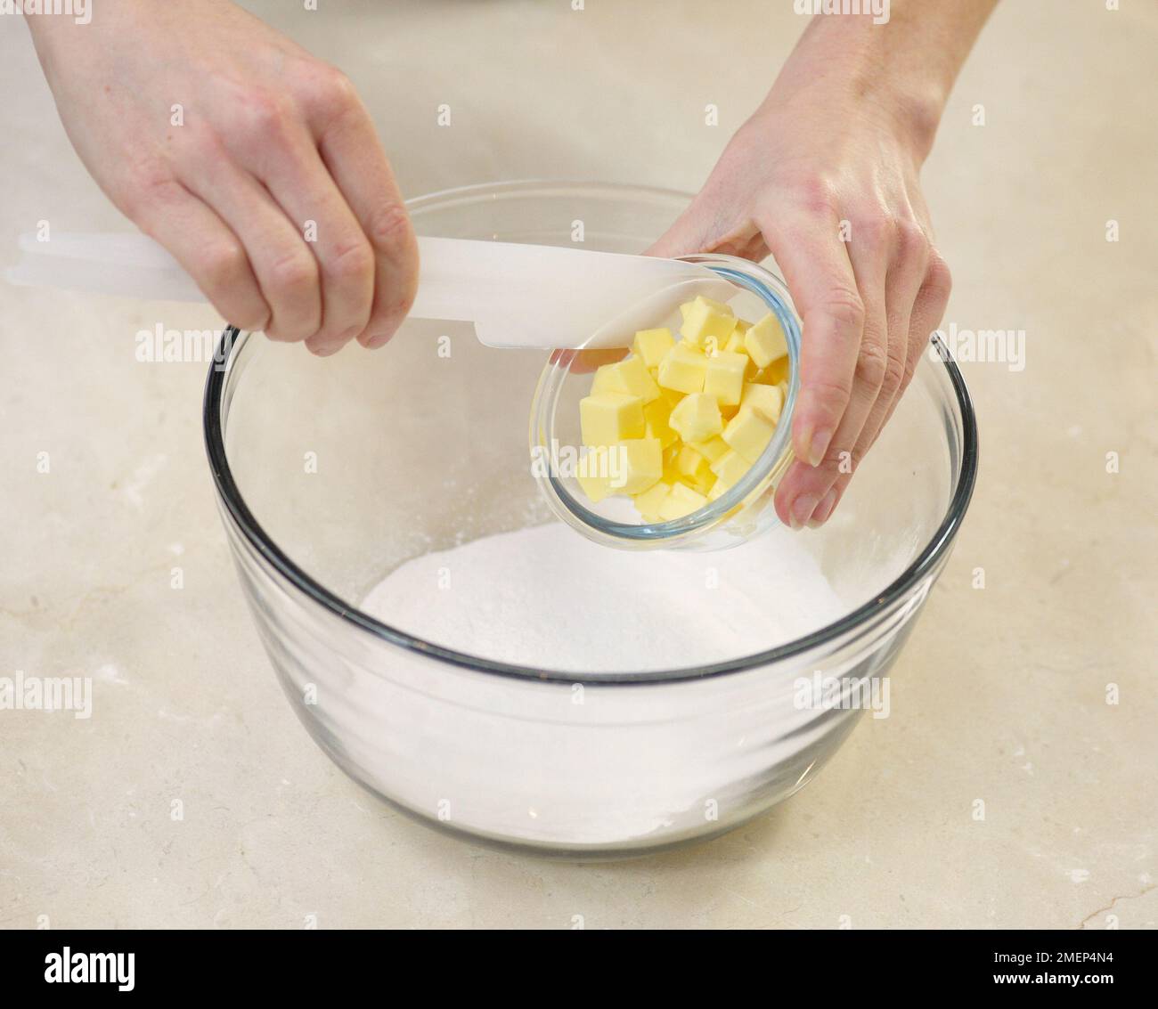 Adding butter cubes to bowl filled with sugar, making Whoopie Pies ...