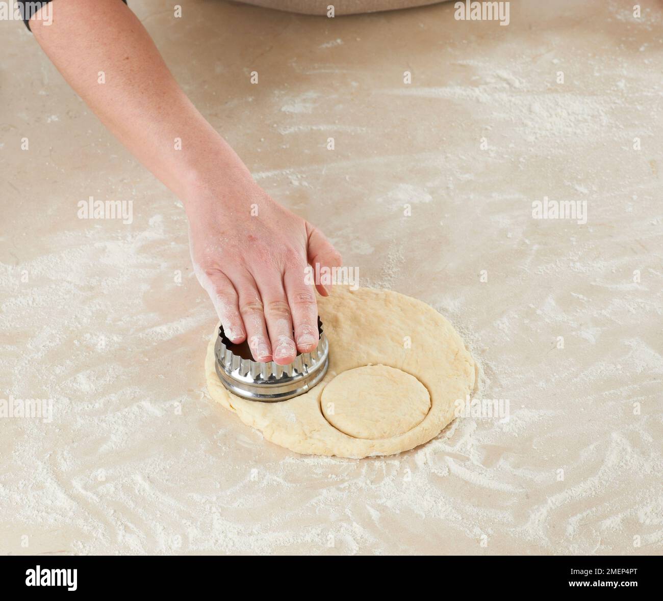 Using pastry cutter to make scones from dough Stock Photo - Alamy