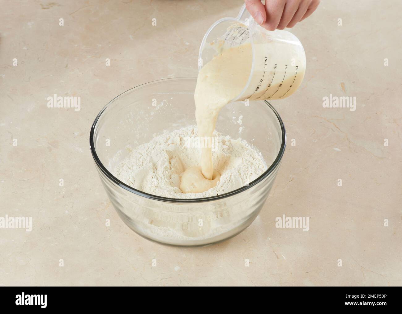 Making Danish Pastries, pouring yeast mixture into bowl containing ...