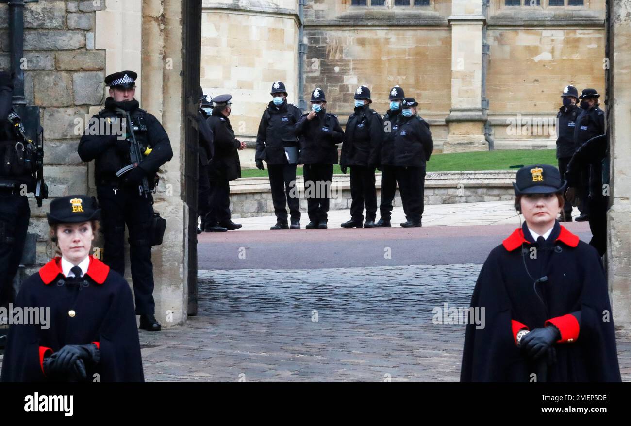 Police officers and Wardens of the Castle stand at the gate of Windsor ...