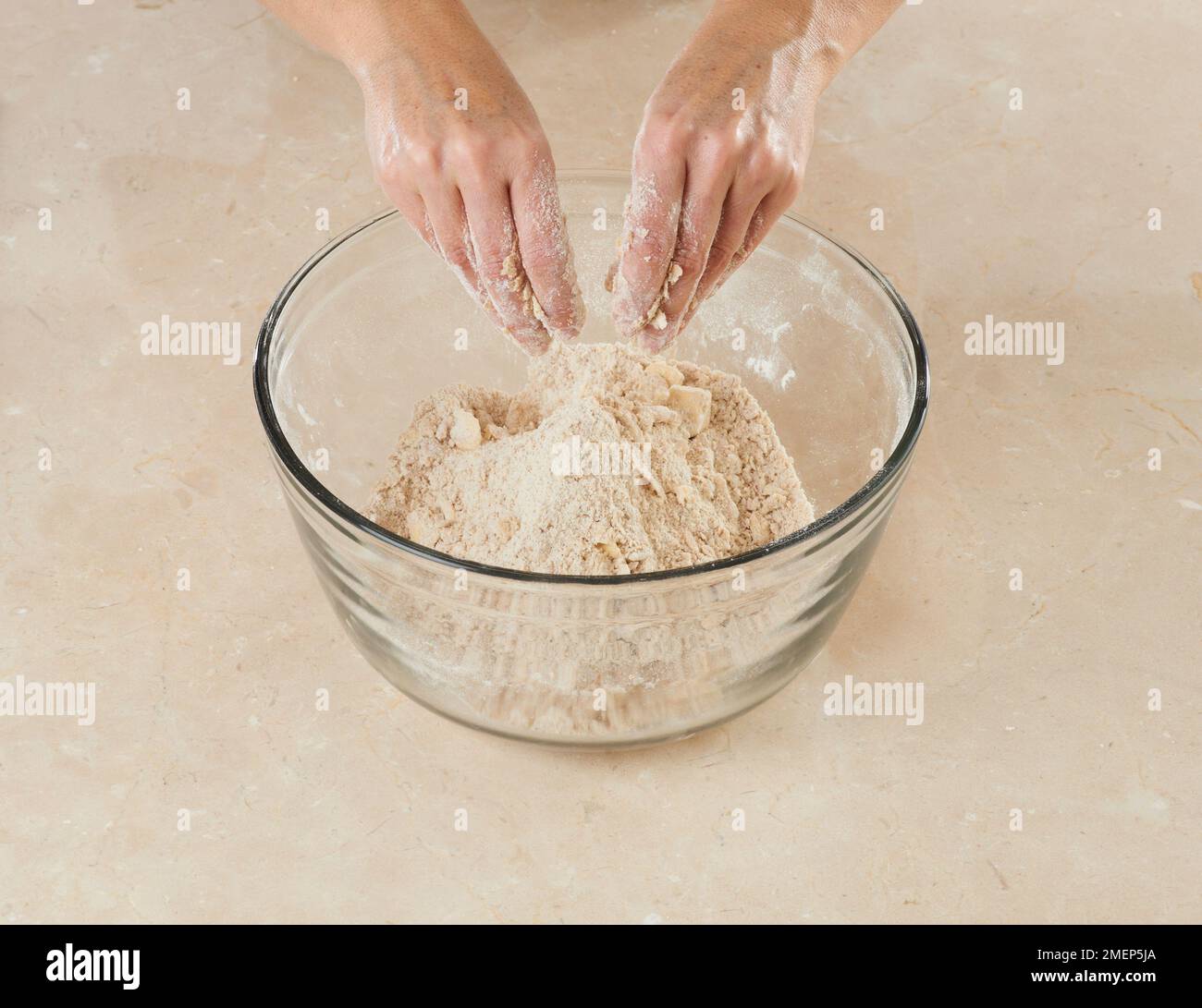 Making Gingerbread Men, Rubbing ingredients together with fingers Stock ...