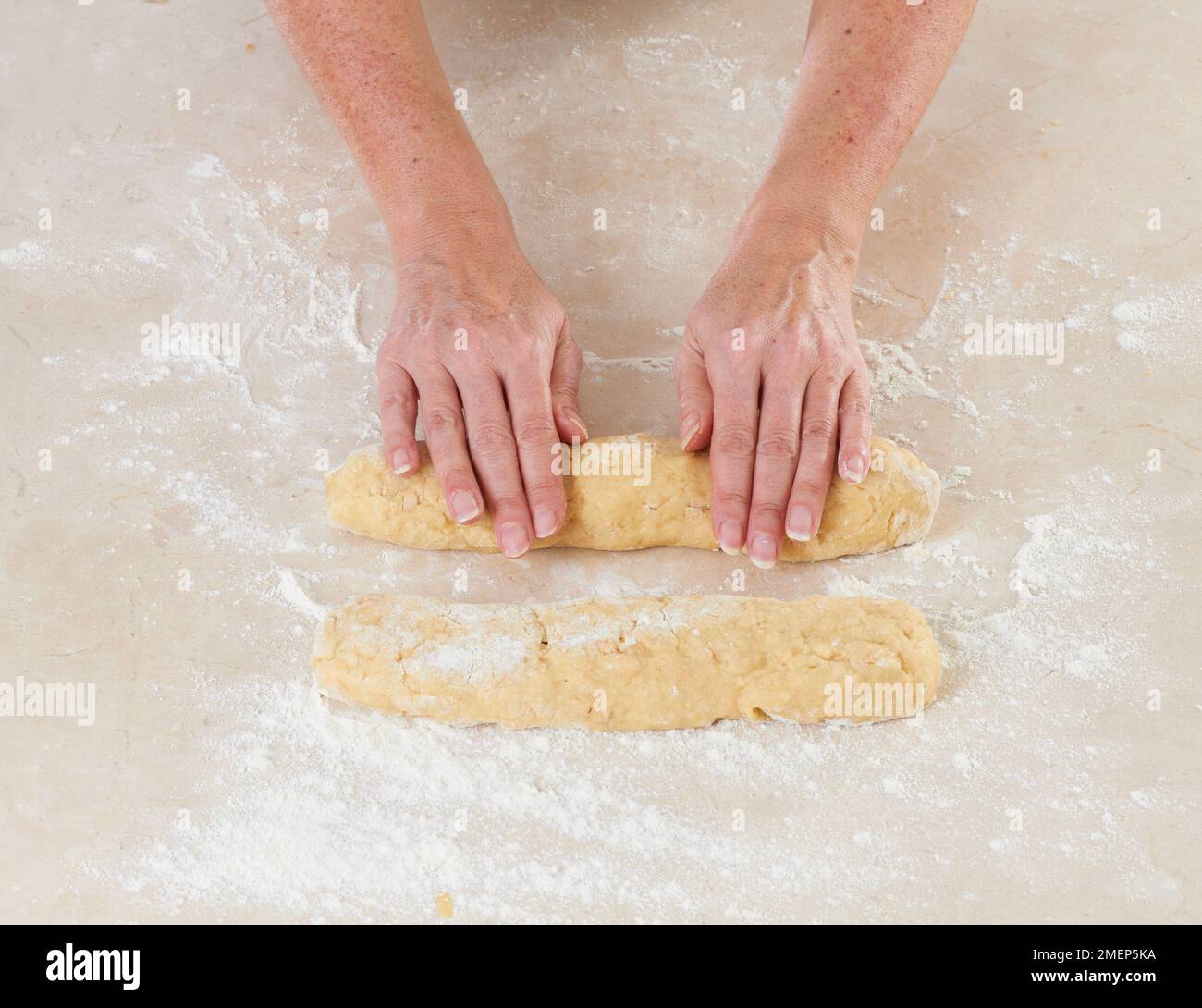 Using hands to shape Biscotti dough on flour Stock Photo - Alamy