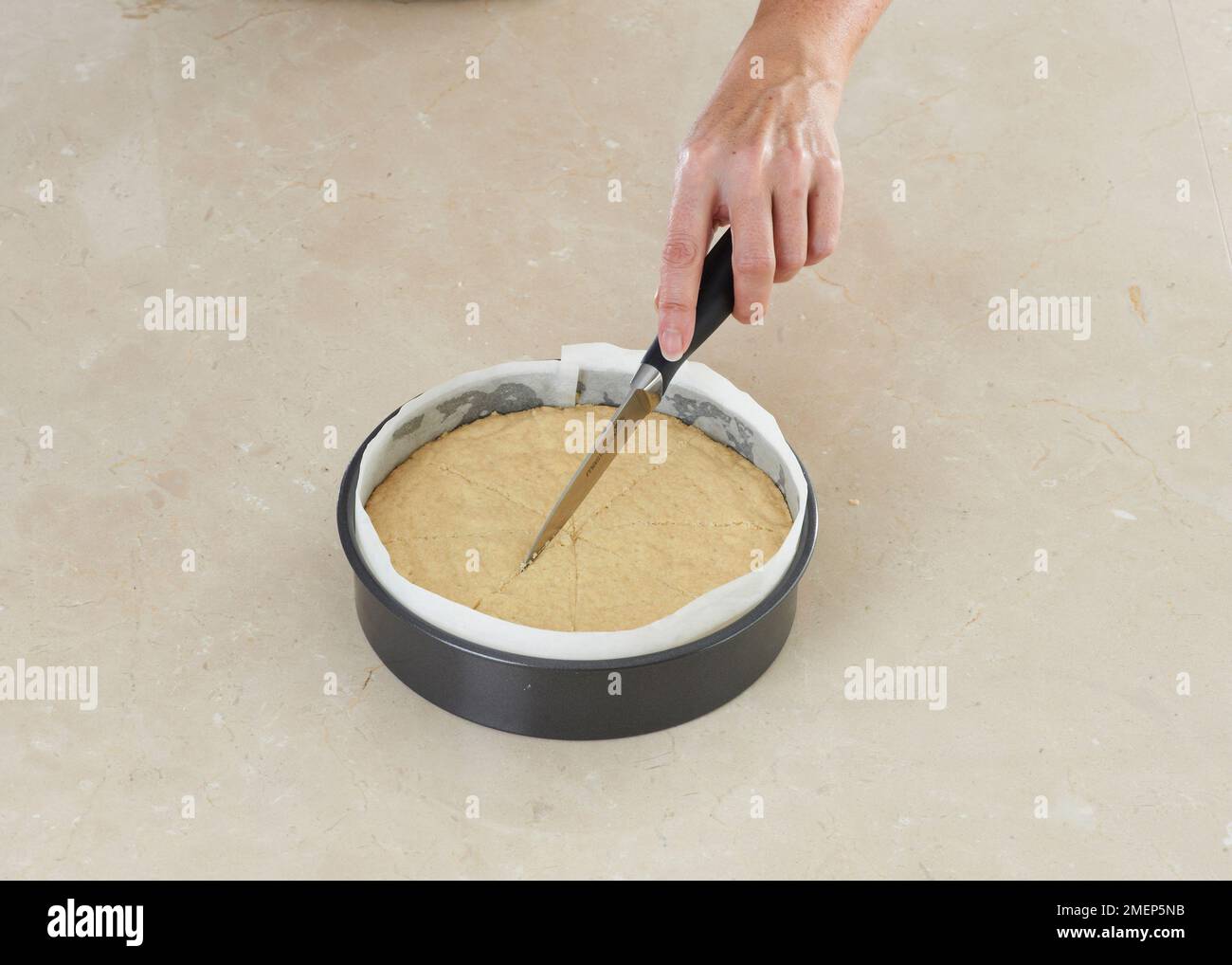 Making Shortbread, lightly re-scoring the baked shortbread into wedges ...