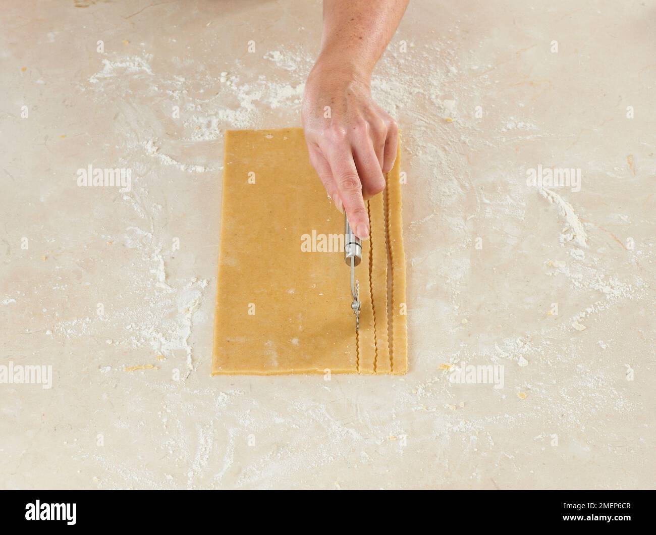 Making traditional Austrian tart, Linzertorte, using fluted wheel to ...