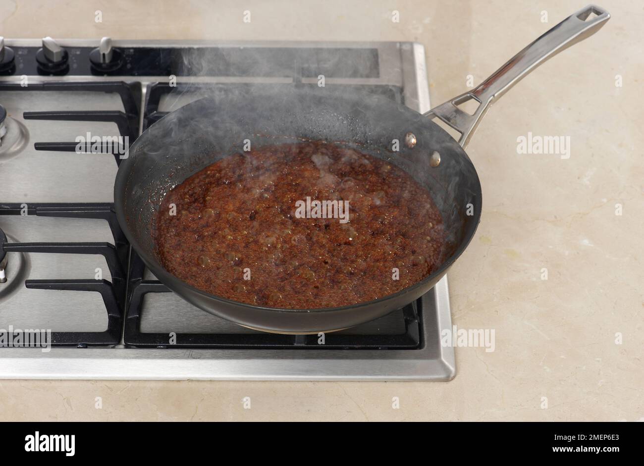 Caramelized sugar in ovenproof pan, making Tarte Tatin Stock Photo - Alamy
