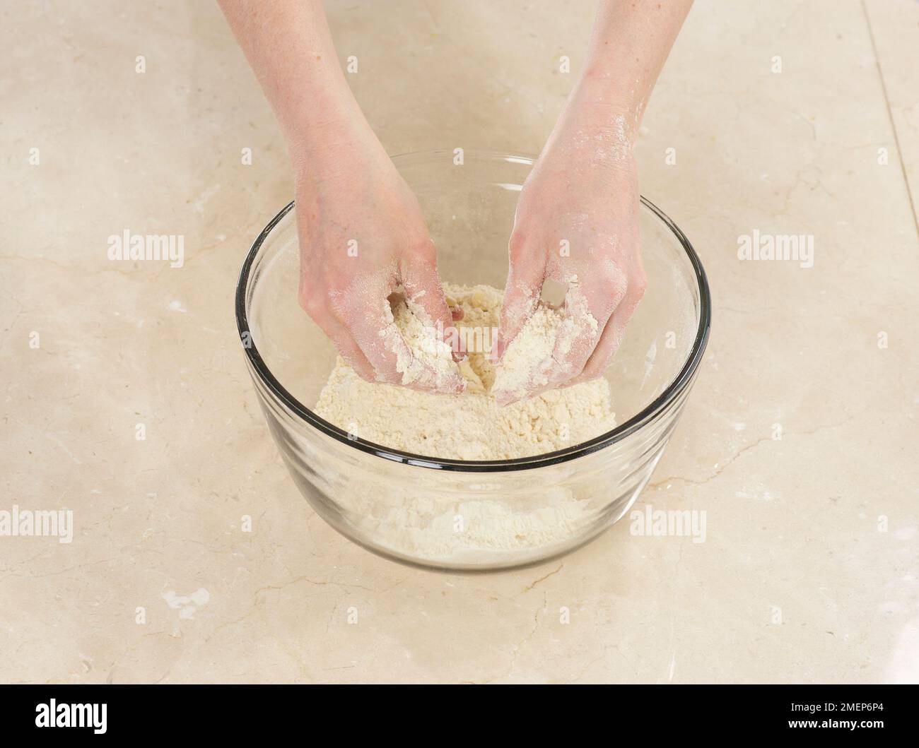 Making cobbler dough, Adding butter and mixing with your fingers until ...