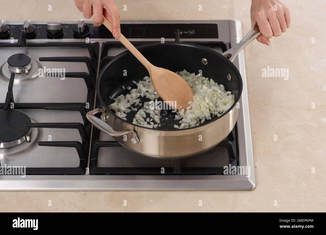 Frying chopped onions in saute pan Stock Photo - Alamy
