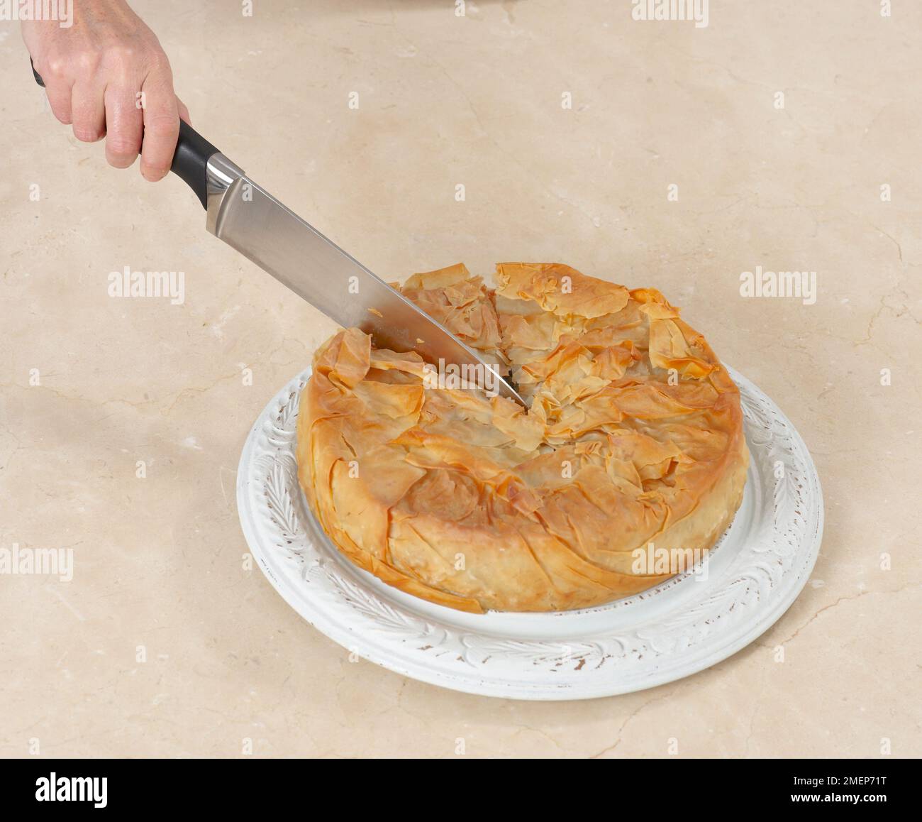 Feta Feta Filo Pie, cutting into slices Stock Photo - Alamy