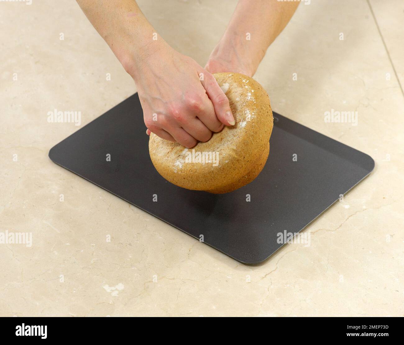 Wholemeal Cottage Loaf, tapping base of loaf Stock Photo - Alamy