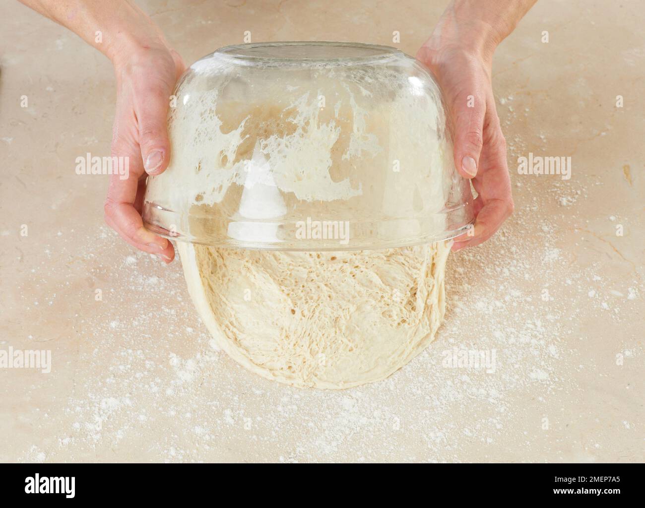 Removing Ciabatta dough from glass mixing bowl Stock Photo - Alamy
