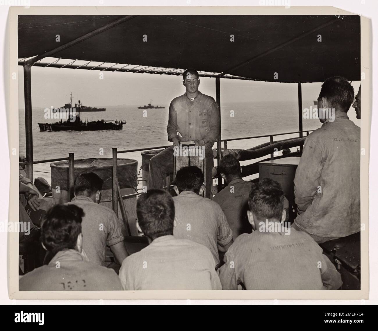 Coast Guardsmen and Marines pray aboard a Coast Guard-manned LST before ...