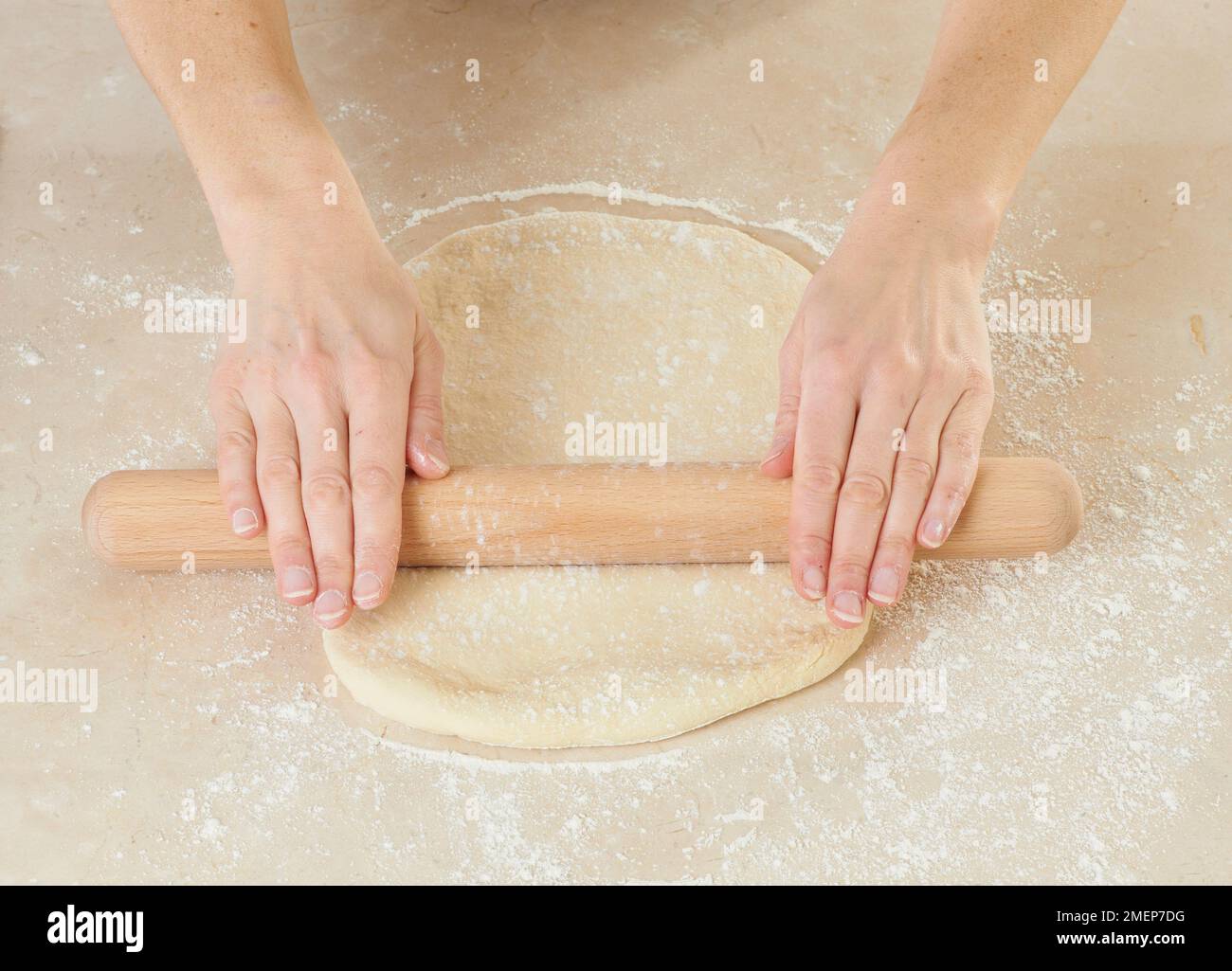 Using rolling pin to roll out Grissini dough Stock Photo - Alamy