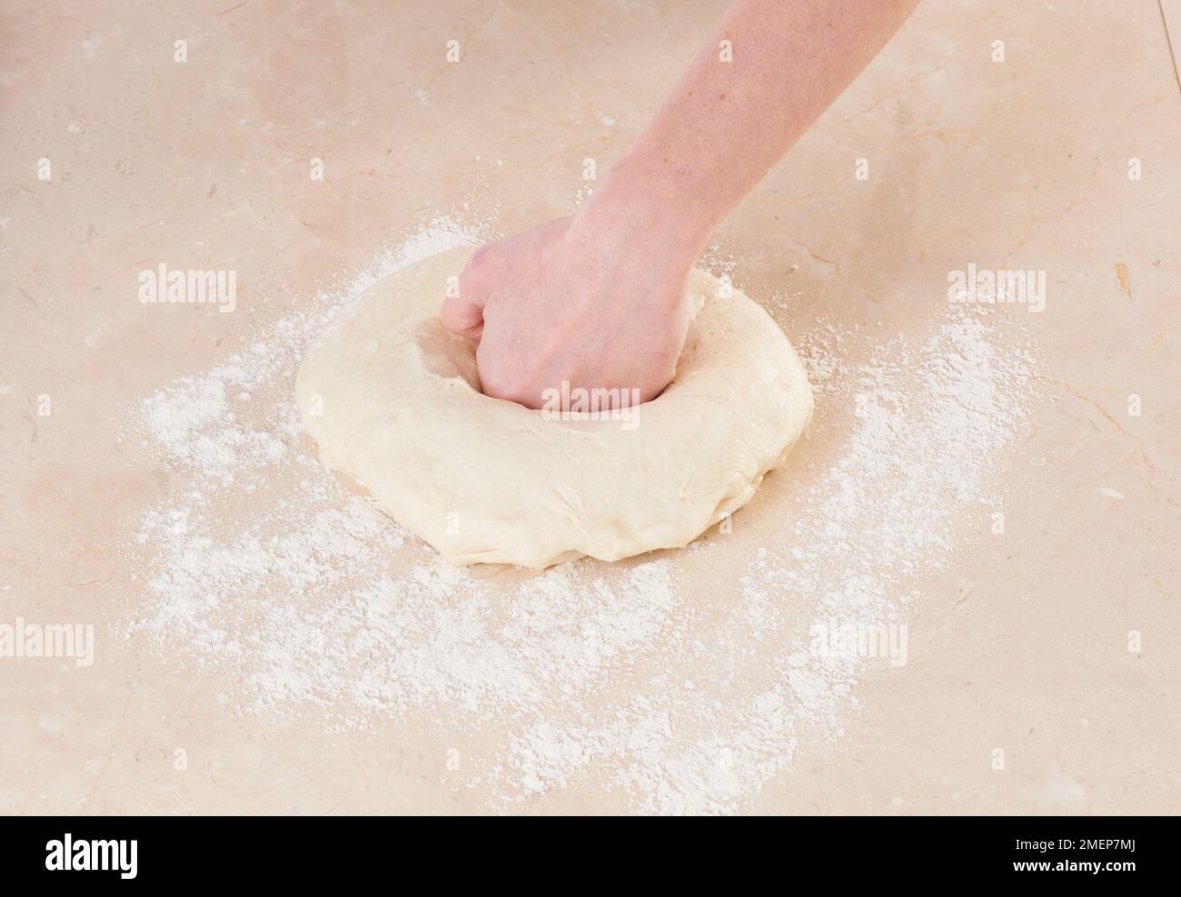 Fist in centre of pretzel dough Stock Photo - Alamy