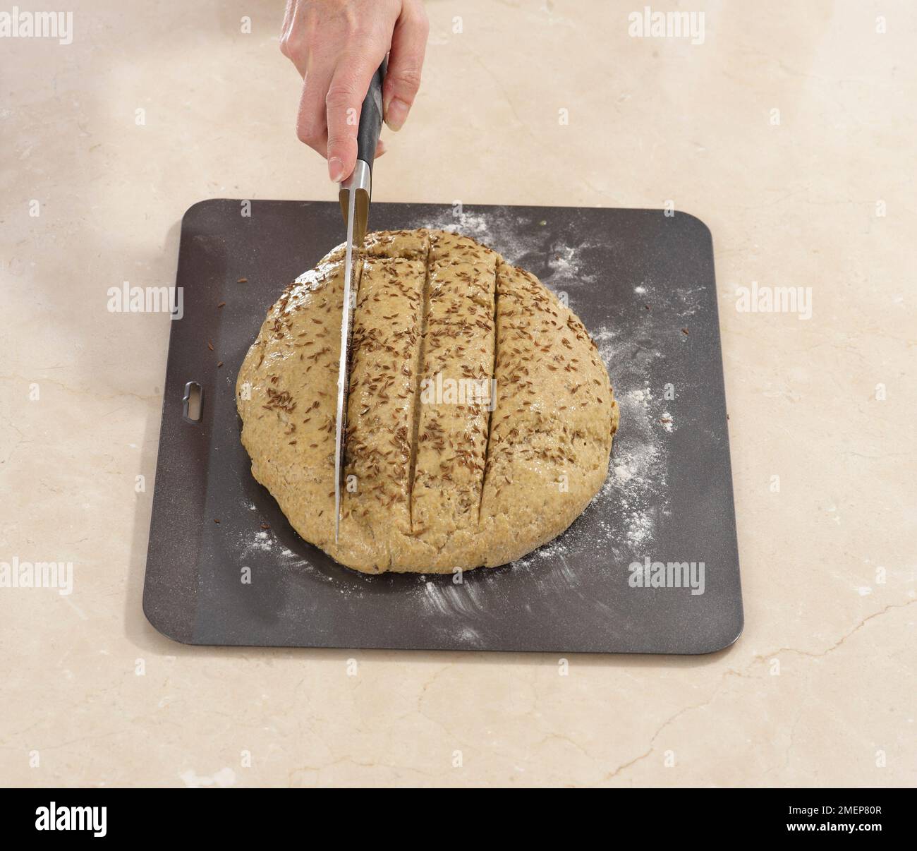 Artisan Rye Bread, slashing the loaf across its length Stock Photo - Alamy