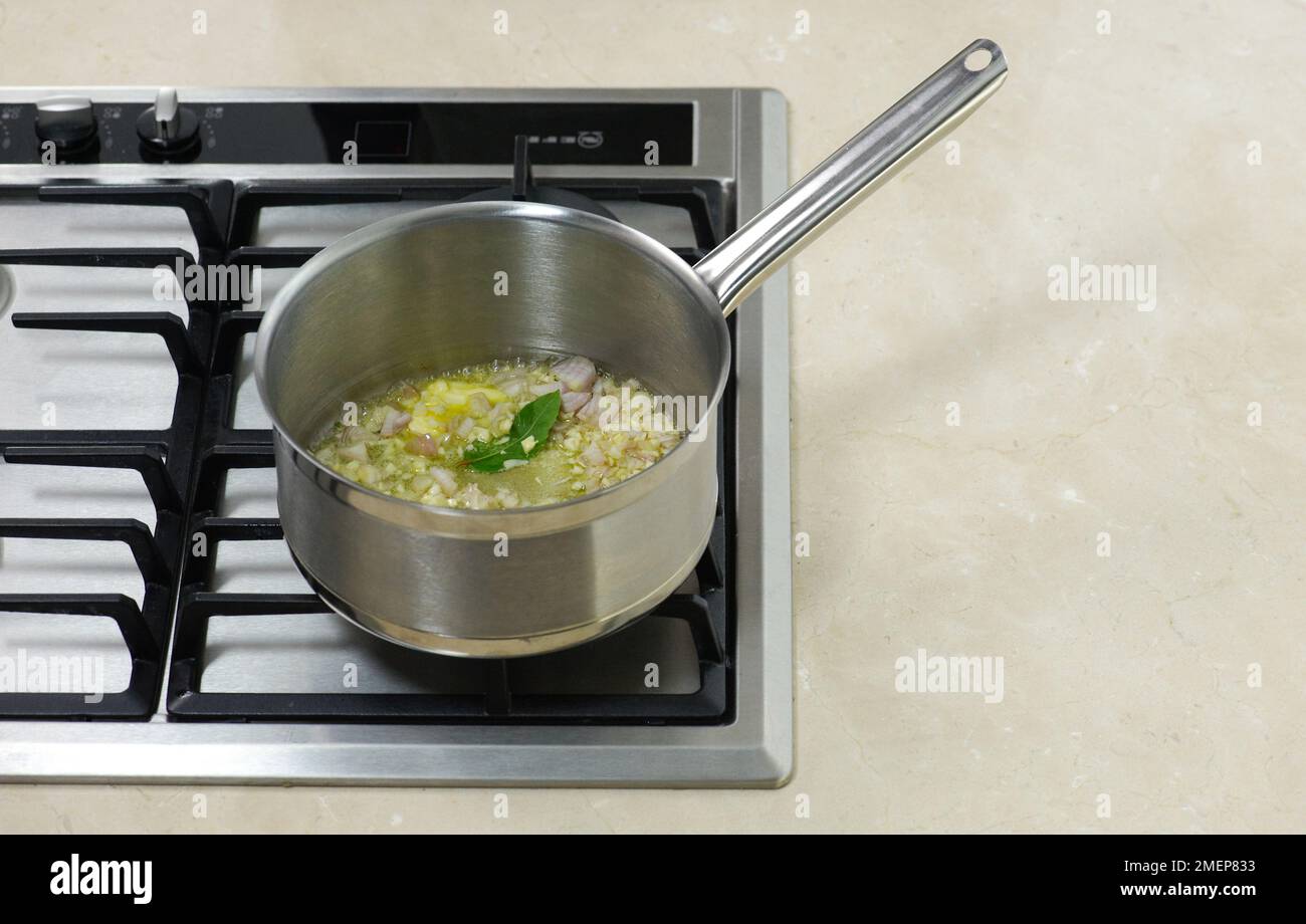 Cooking tomato sauce for pizza base, sweating the ingredients together ...