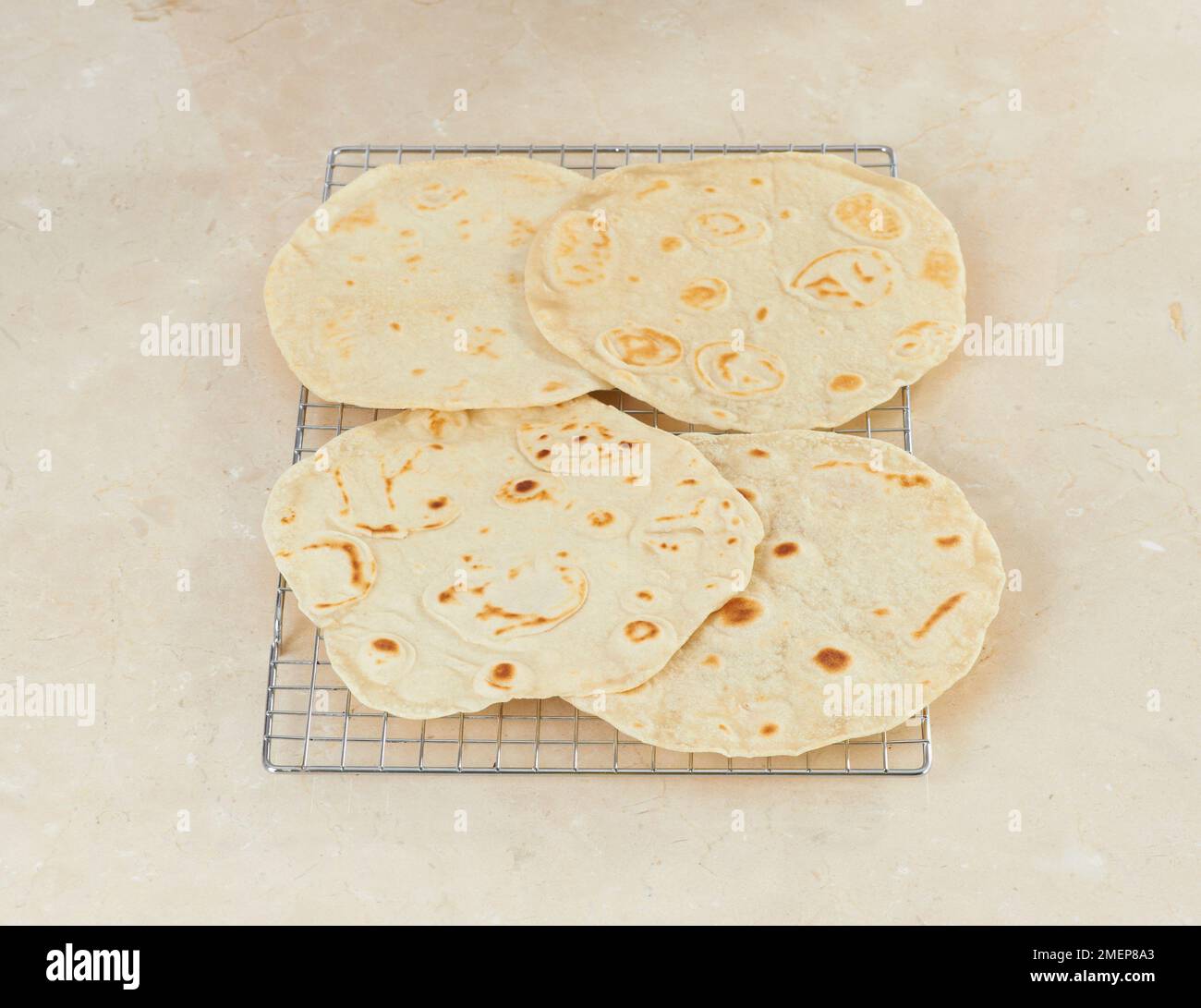 Tortillas on wire cooling tray on kitchen worktop Stock Photo - Alamy