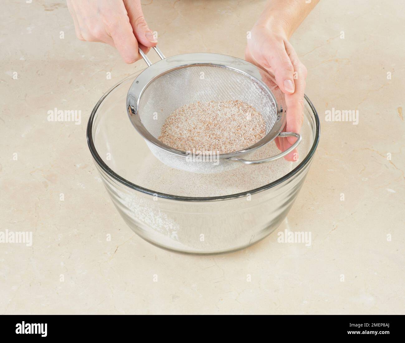 Making Soda Bread, sifting bicarbonate of soda and wholemeal flour into ...