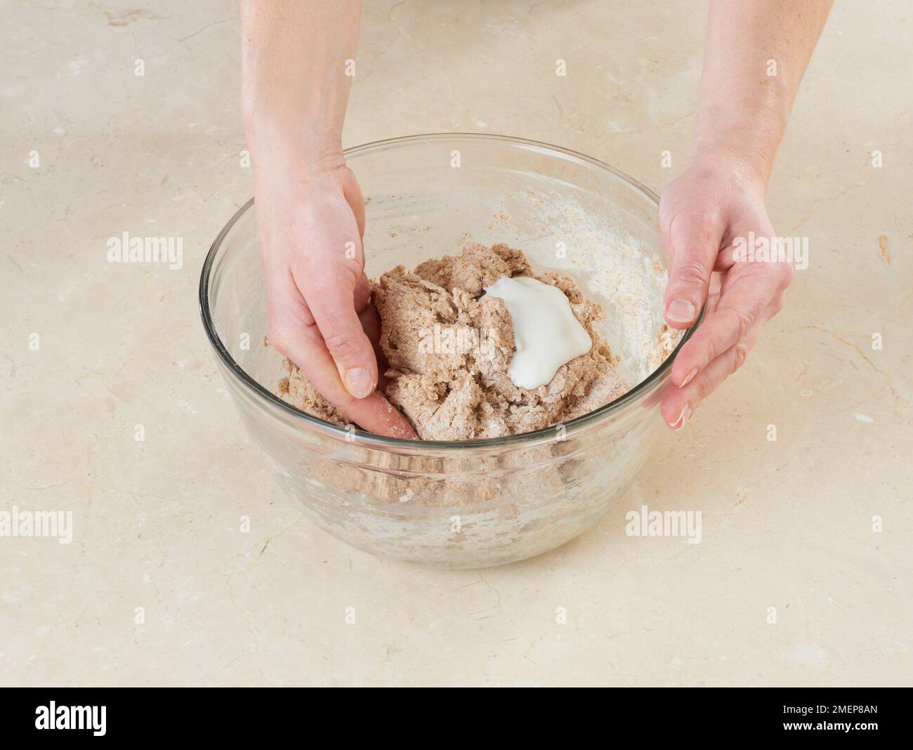 Making Soda Bread, mixing together flour and buttermilk, and adding extra buttermilk if ...