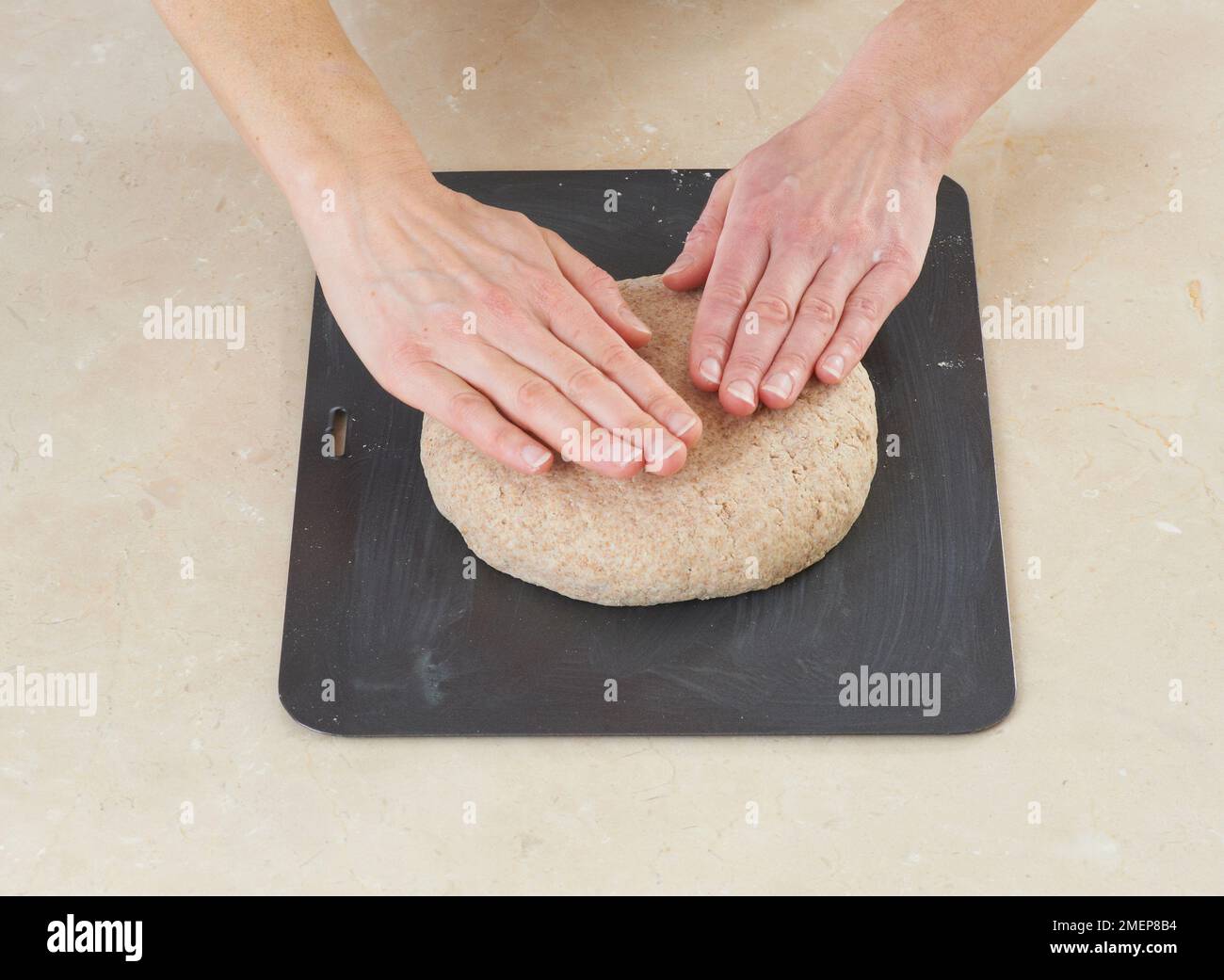 Making Soda Bread, putting loaf on baking sheet and patting it down ...