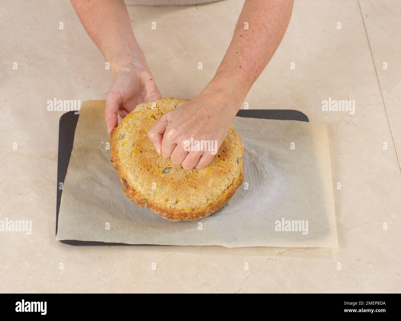 Tapping base of baked Pumpkin Bread, soda bread Stock Photo - Alamy