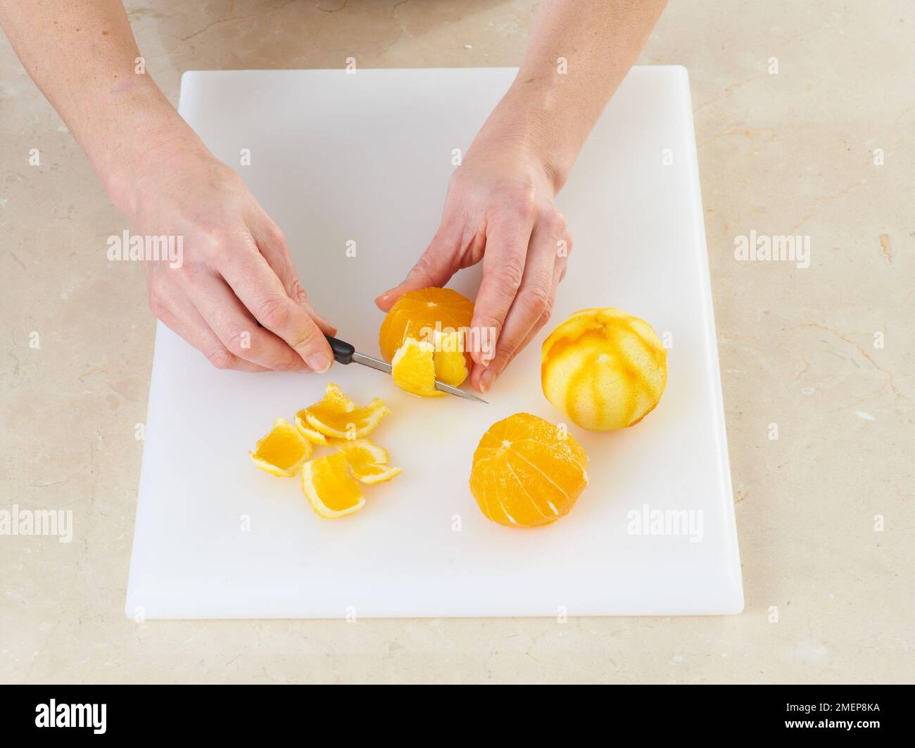 Cutting pith and skin from oranges, to make orange butter for Crepes ...