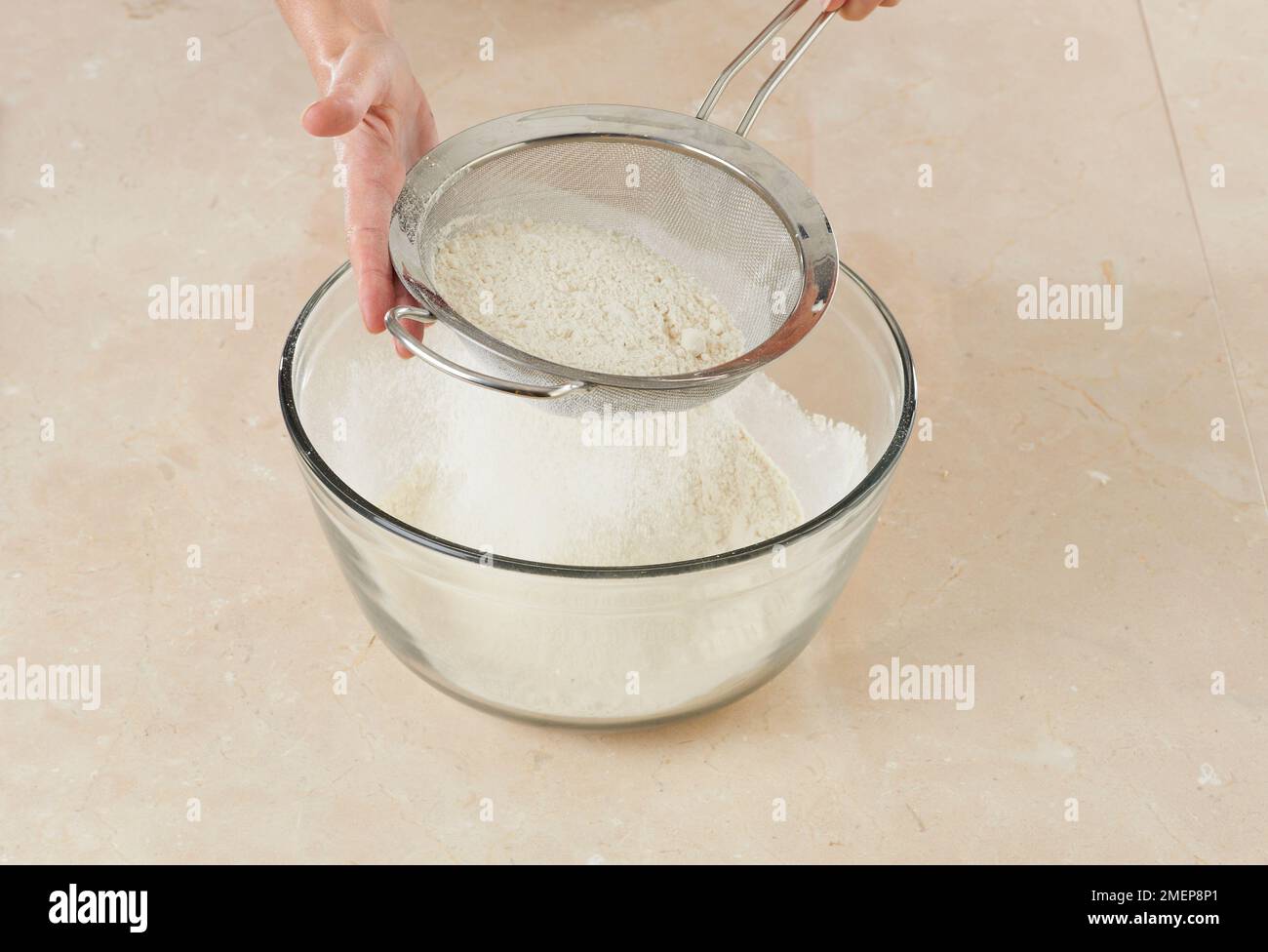 Making Brioche des rois, sifting together flour, salt and adding the ...