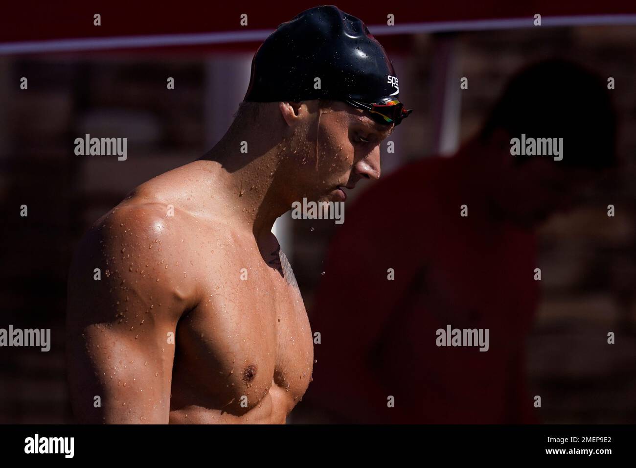 Caeleb Dressel walks away from the pool after competing in the men's ...