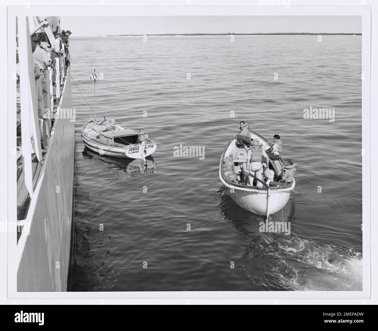 A photograph shows Cuban refugees being rescued by the U.S. Coast Guard ...