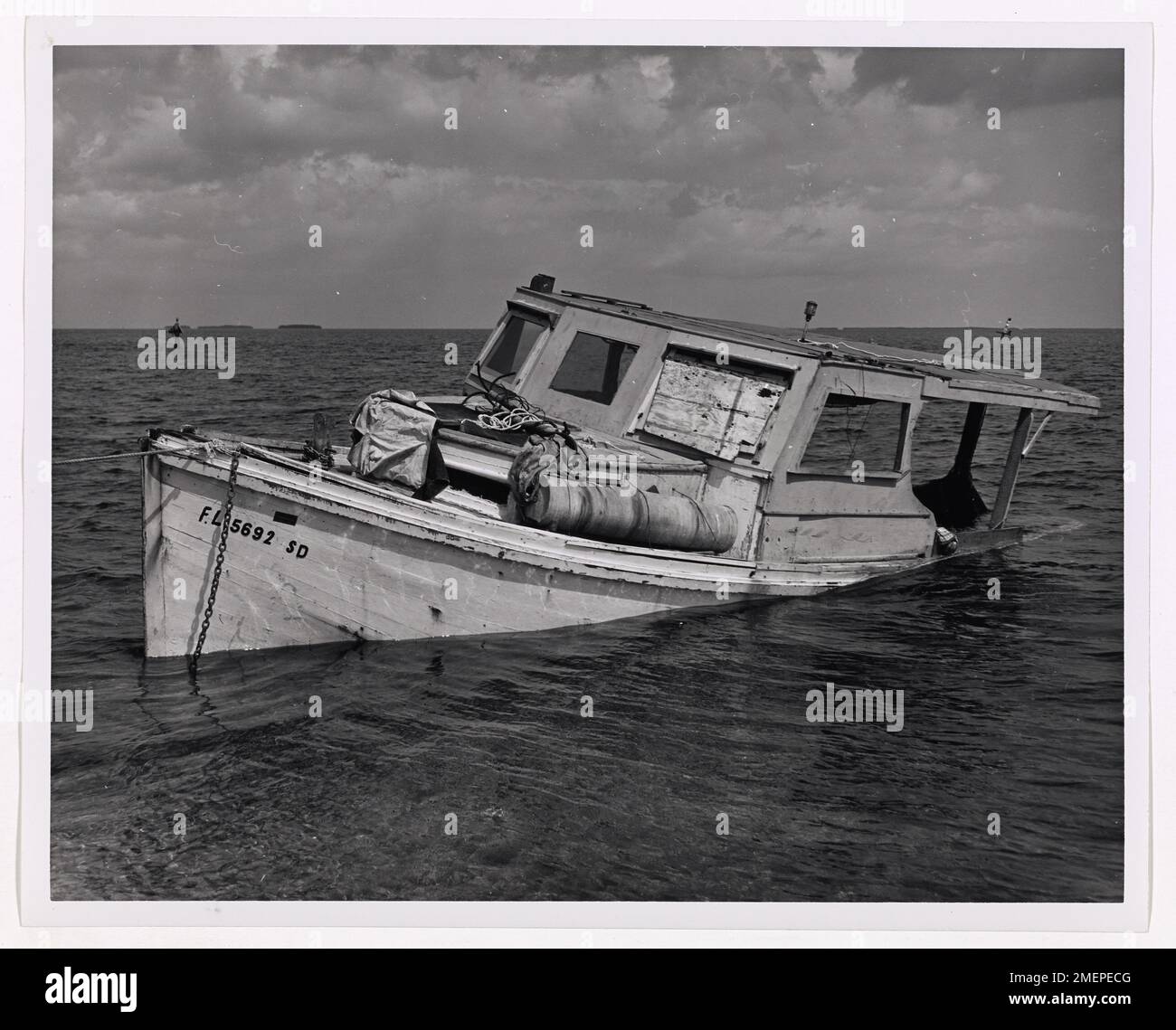 This image depicts a boat that sank at Key West, Florida, now impounded ...