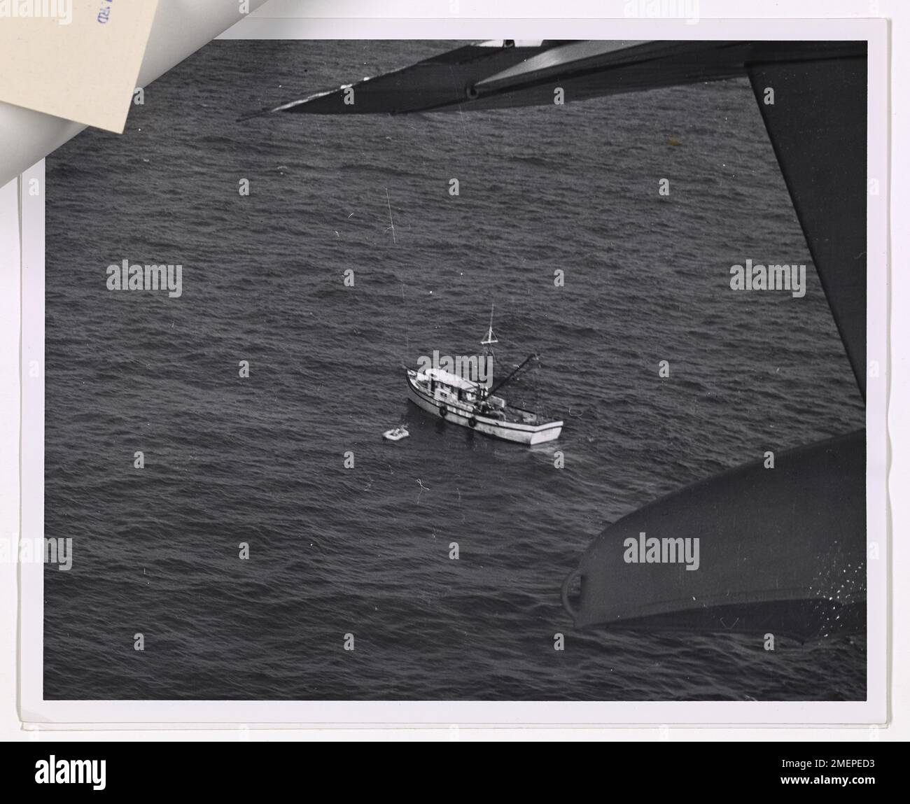 A Coast Guard aircraft assists in rescuing injured seamen from the ...