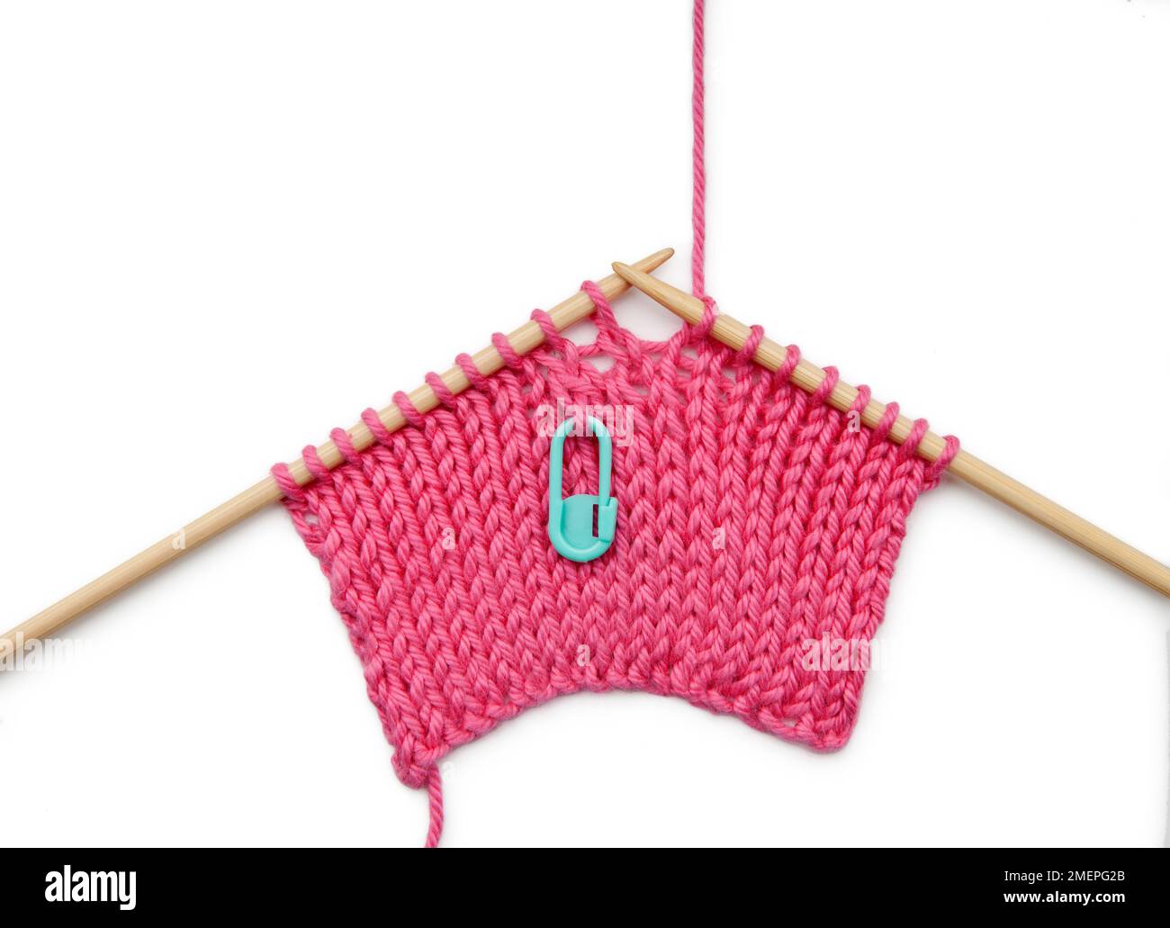Raised central increase knitting technique using stitch holder, close ...