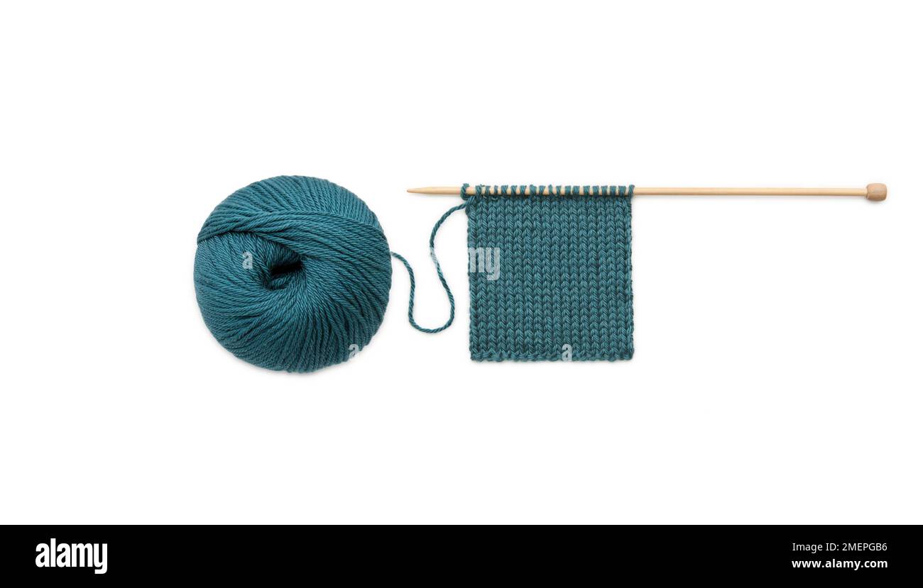 Ball of mix of natural and synthetic yarn and knitted sample on ...