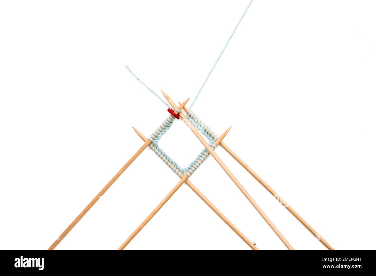 Working with a set of five double-pointed needles Stock Photo - Alamy