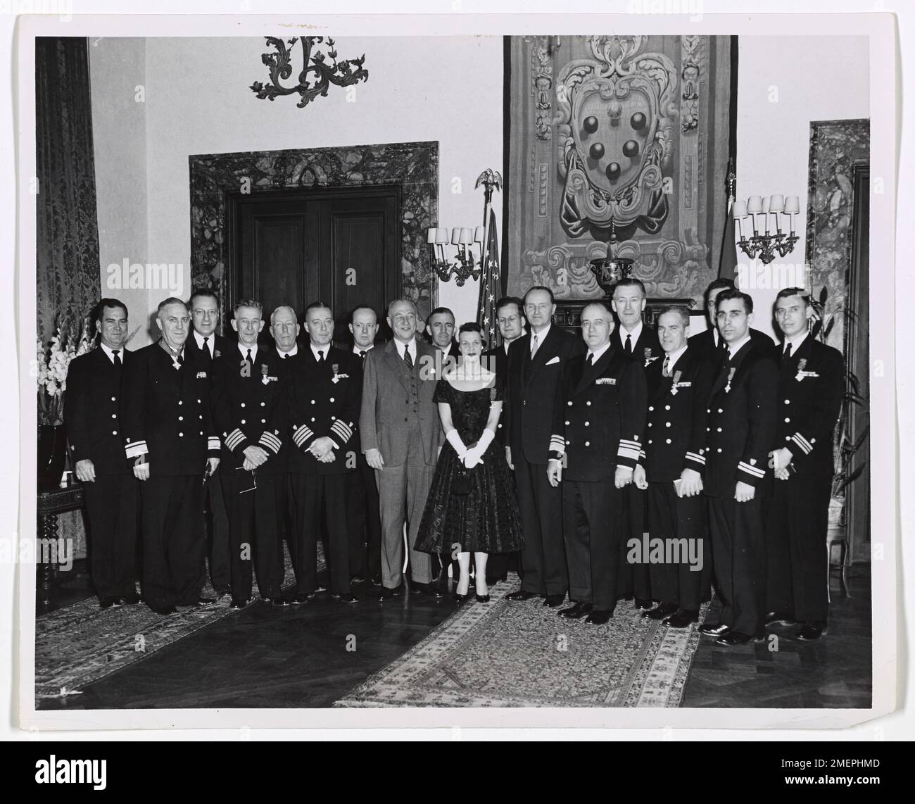 Fifteen U.S. Coast Guardsmen and Navy personnel are photographed at the ...