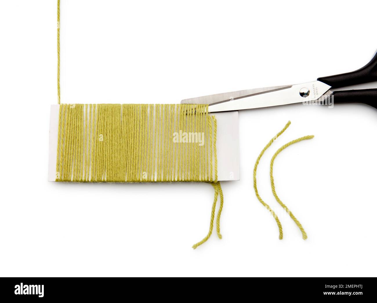 Making a fringe - cutting yarn on template Stock Photo - Alamy