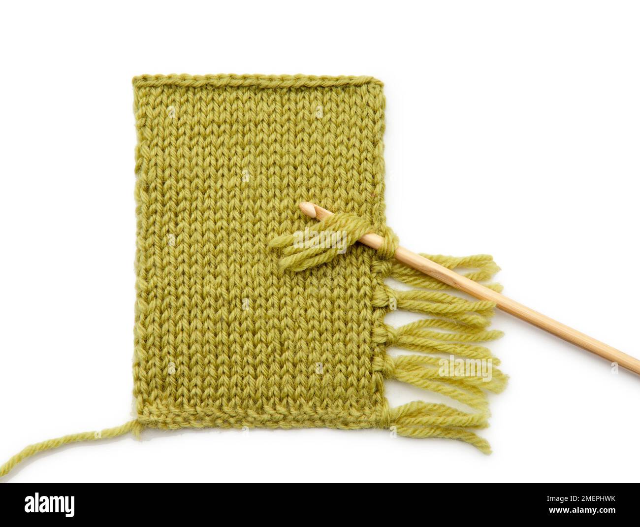 Making a fringe in knitting sample Stock Photo - Alamy